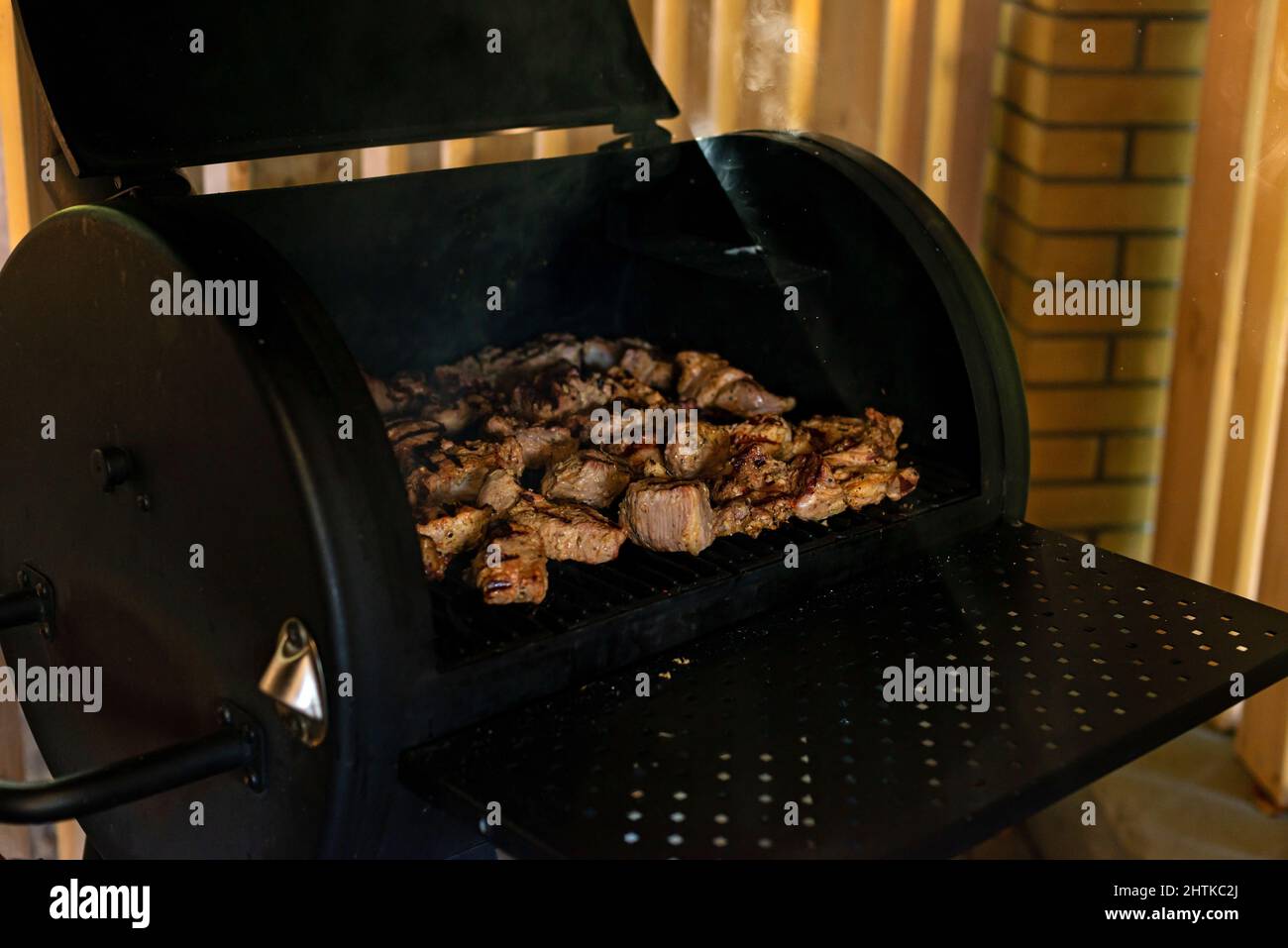 Juicy cuts of beef and pork meat on an open grill. Summer vacation ...
