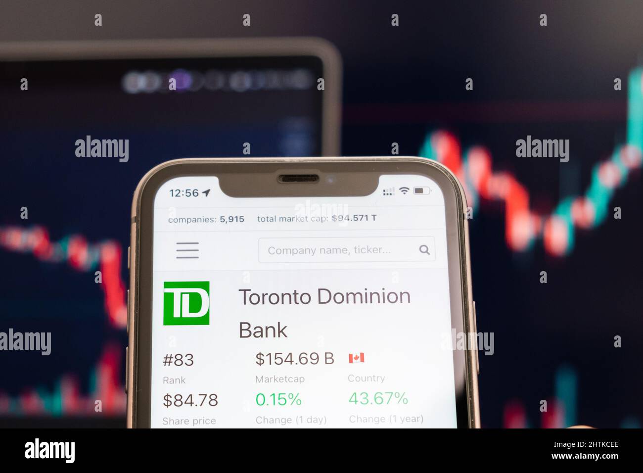 Toronto Dominion Bank stock price on the screen of cell phone in mans ...