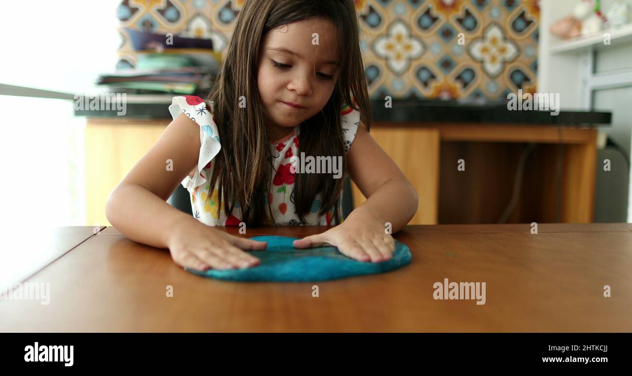 Child hands playing with slime goo. Little girl close-up hand and ...