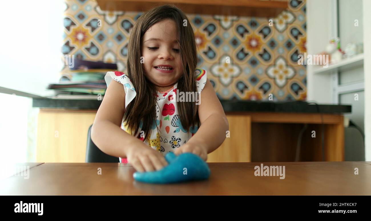 Child hands playing with slime goo. Little girl close-up hand and ...