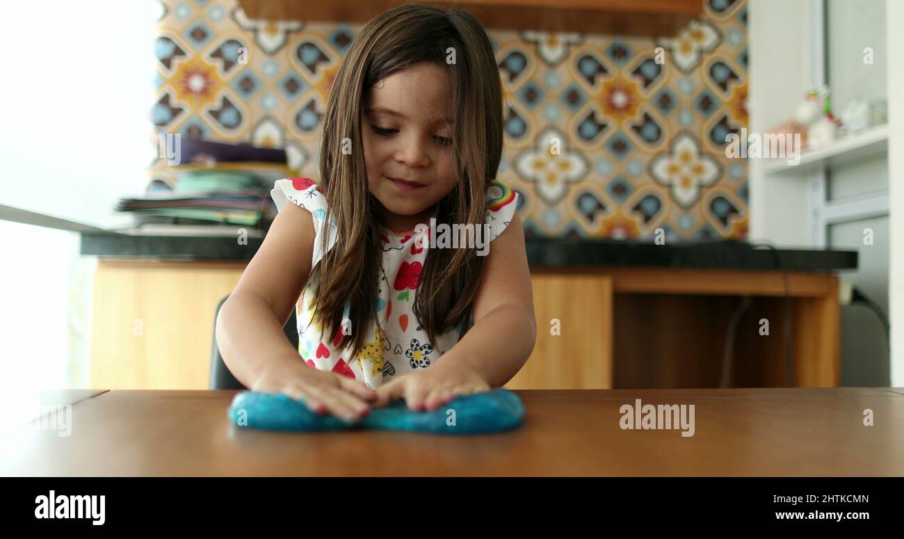 Child hands playing with slime goo. Little girl close-up hand and ...