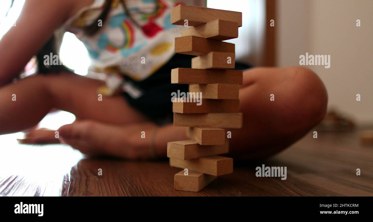 Child playing with wooden building blocks. Kid trial and error play ...