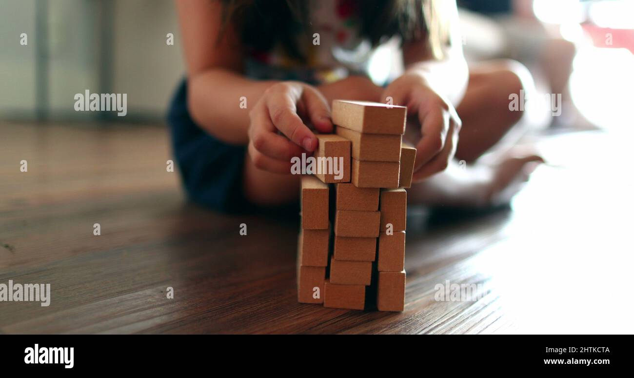 Child playing with wooden building blocks. Kid trial and error play ...