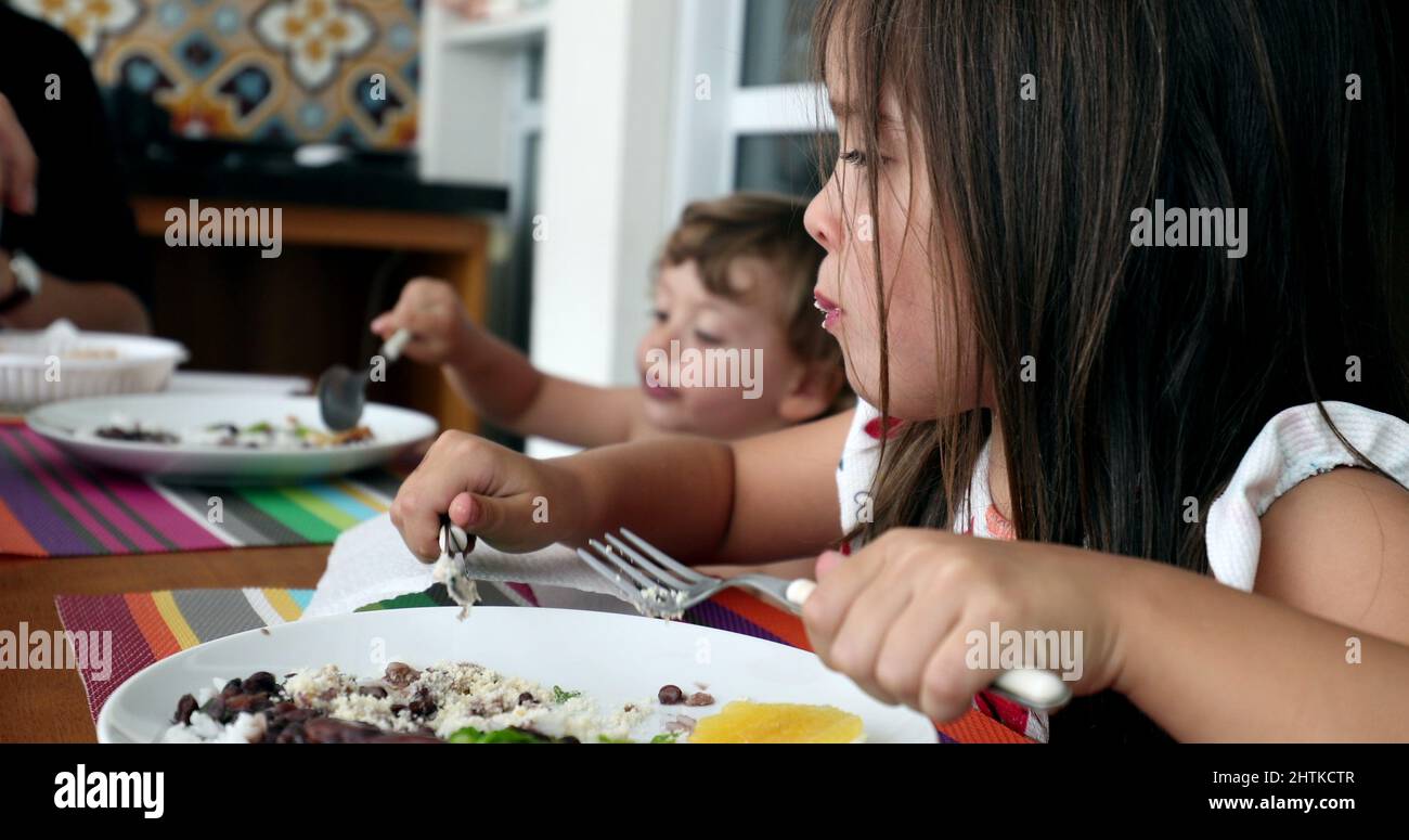 Little girl eating lunch at meal table Stock Photo - Alamy