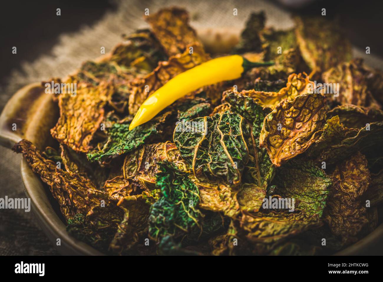 Homemade baked cabbage chips on dark wooden background, close up Stock ...