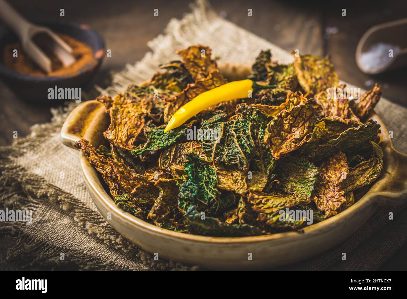 Homemade baked savoy cabbage chips on dark wooden background Stock ...
