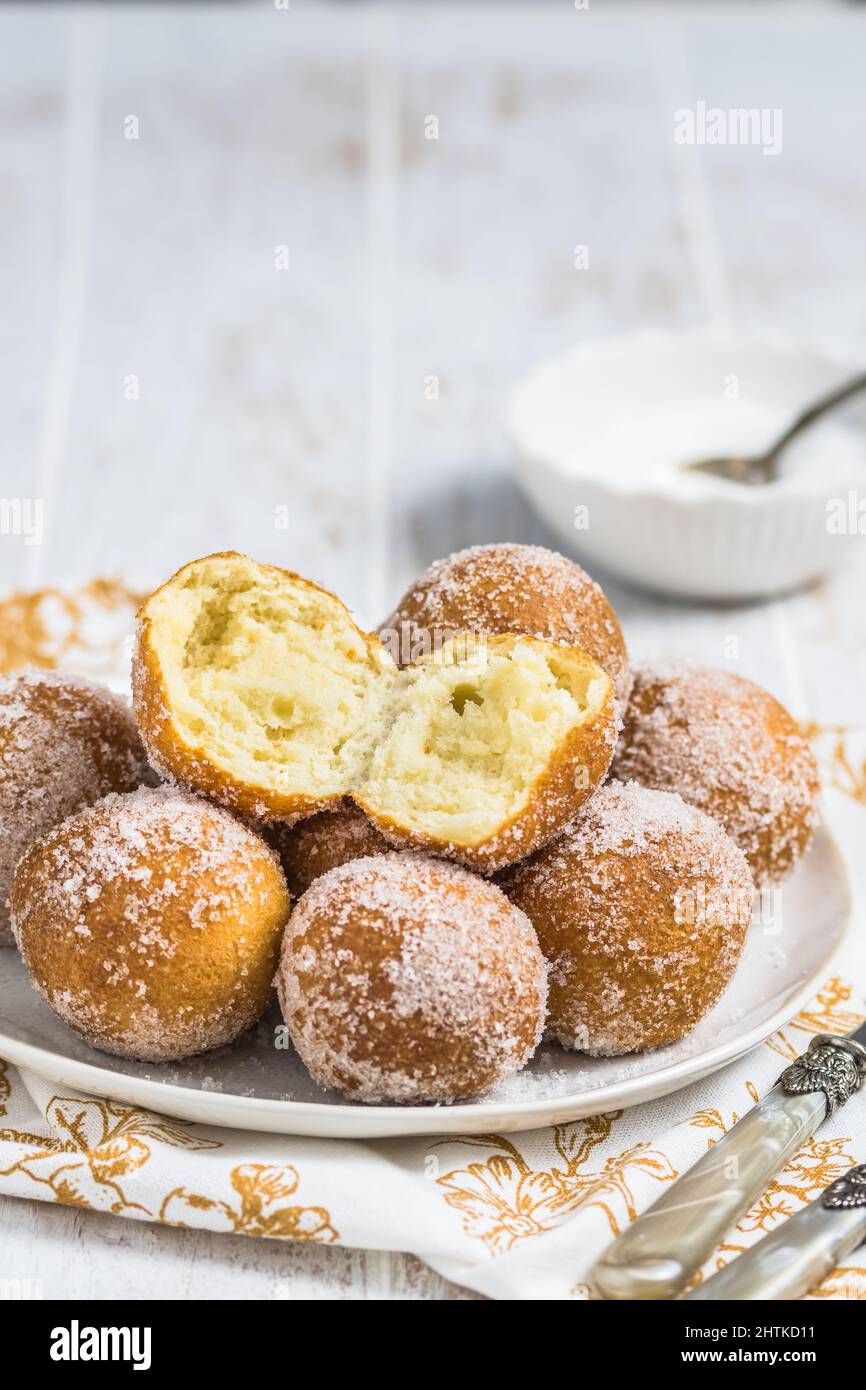 Fried curd balls with sugar on white wooden background. Concept of ...