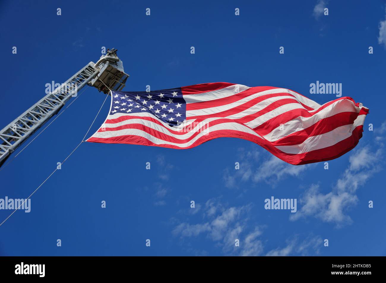 The American flag flies from a snorkel or aerial work platform Stock ...