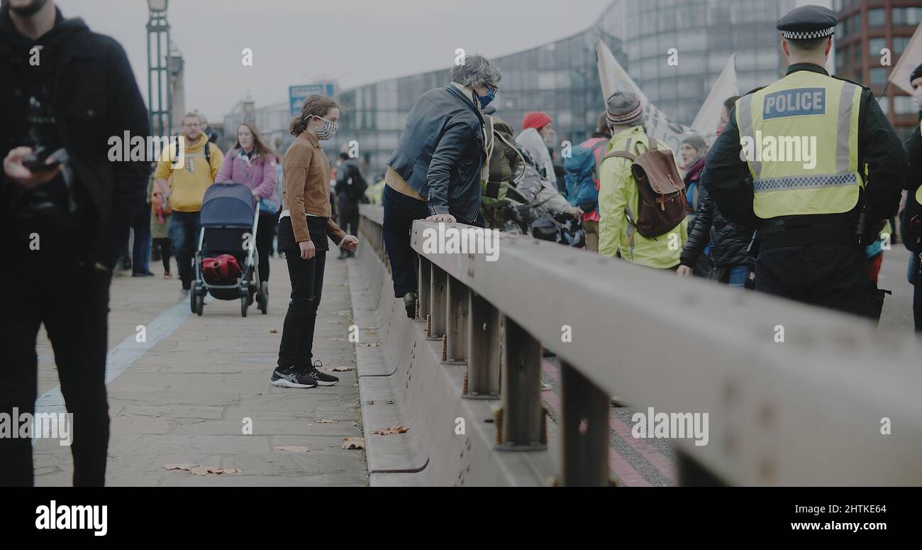 London, UK - 11 20 2021: A young girl protester wearing a face mask ...