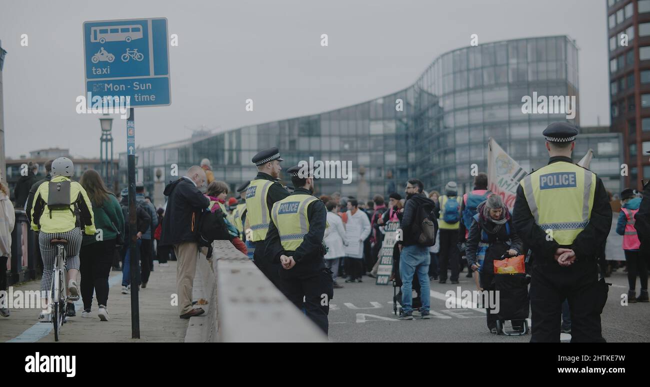 London, UK - 11 20 2021: Police officers on Lambeth Bridge with a crowd ...