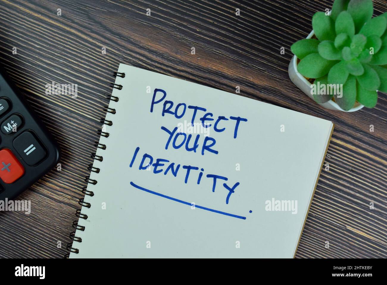 Protect Your Identity write on a book isolated on Wooden Table Stock ...