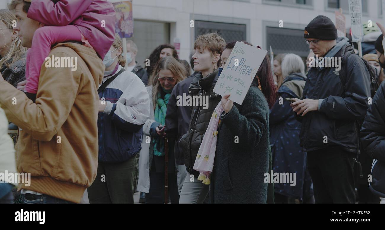 London, UK - 11 06 2021: A young woman climate activist holding a sign ...