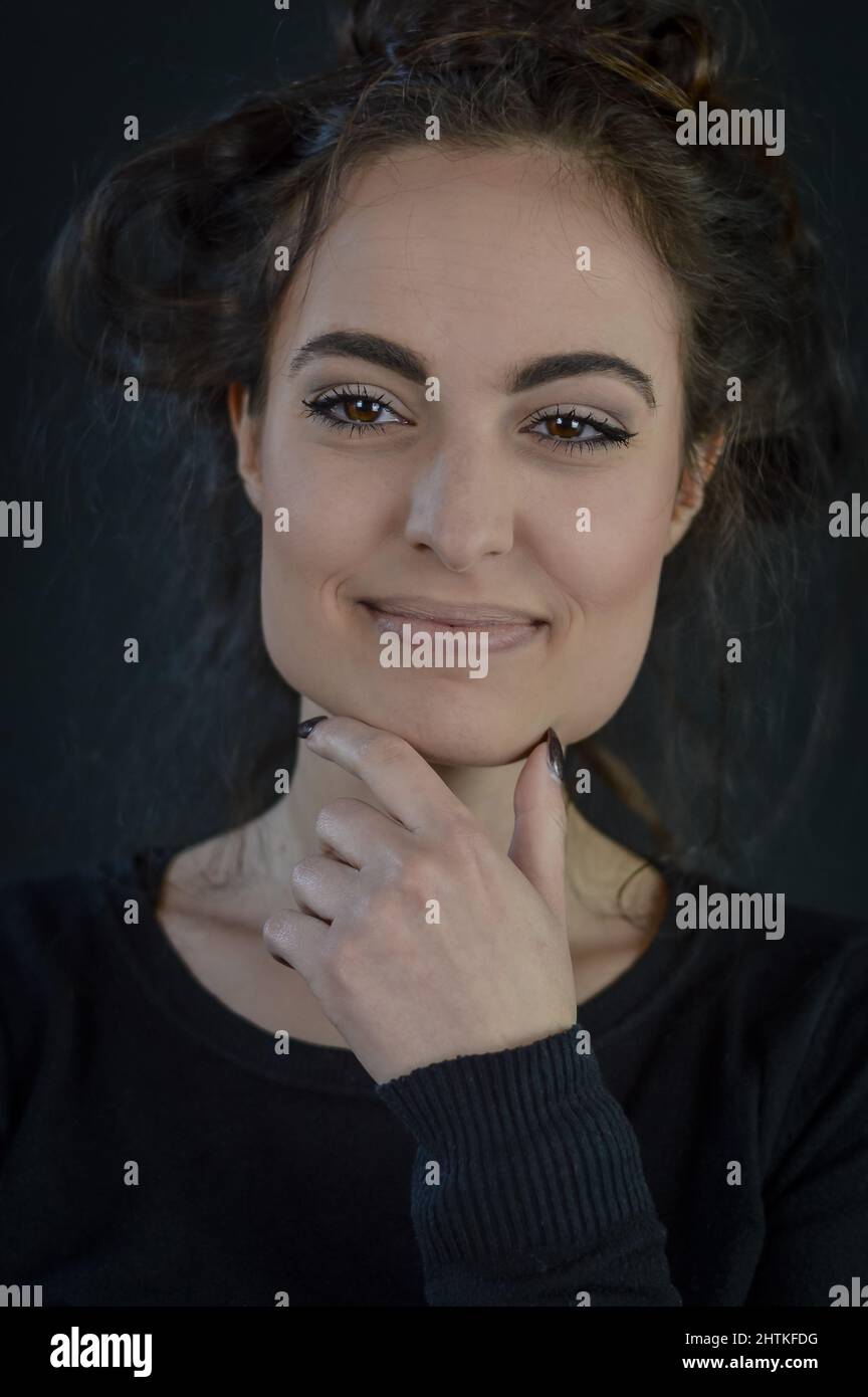 Portrait of a beautiful young Italian woman with coarsely gathered hair ...