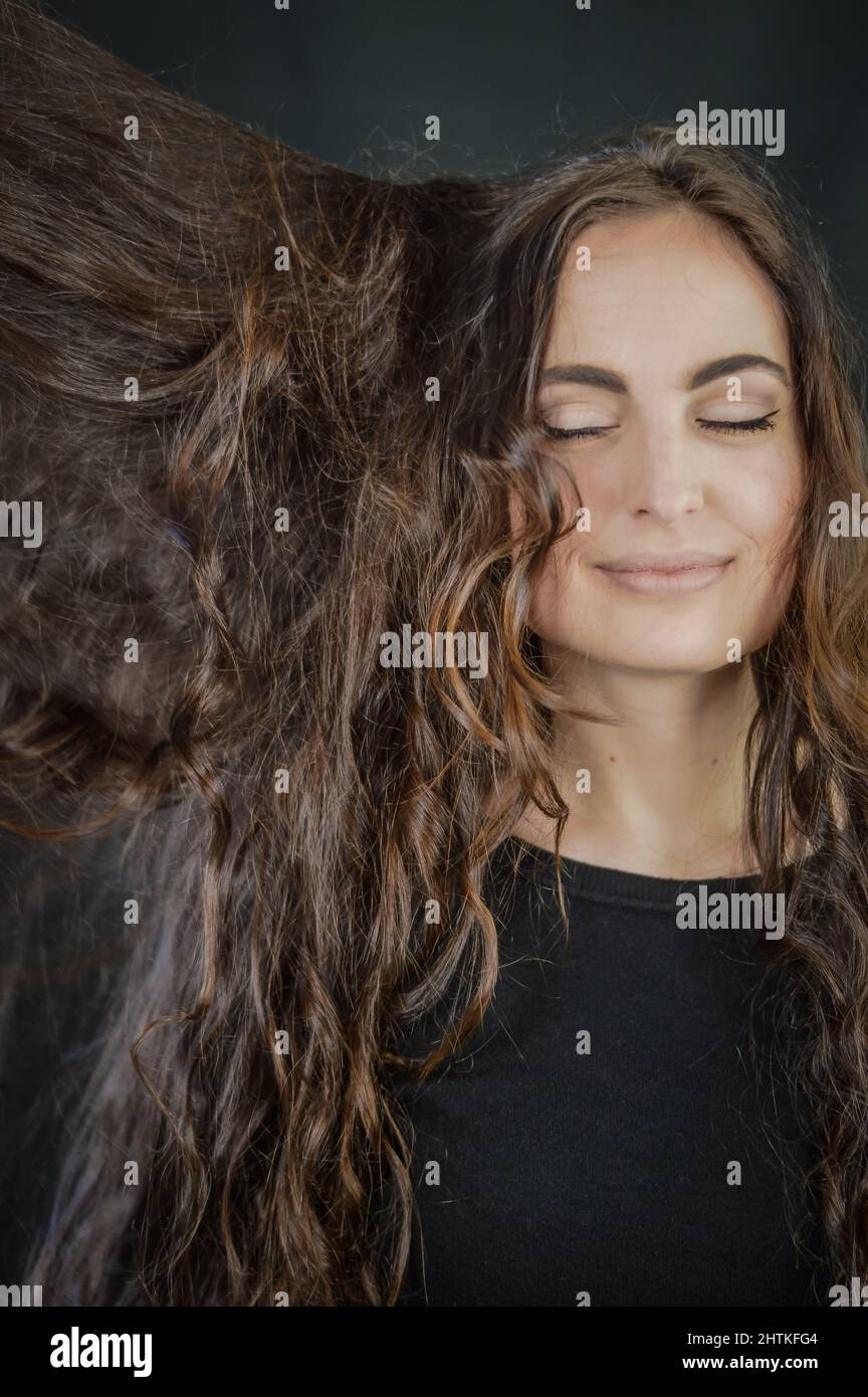 Portrait of a beautiful young Italian woman with very long brown hair ...