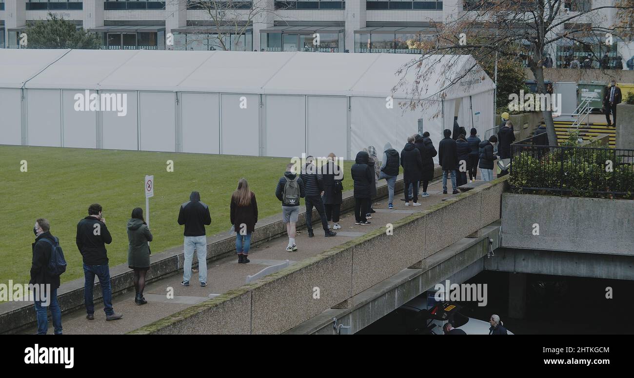 London, UK - 12 13 2021: People waiting in line for their booster ...