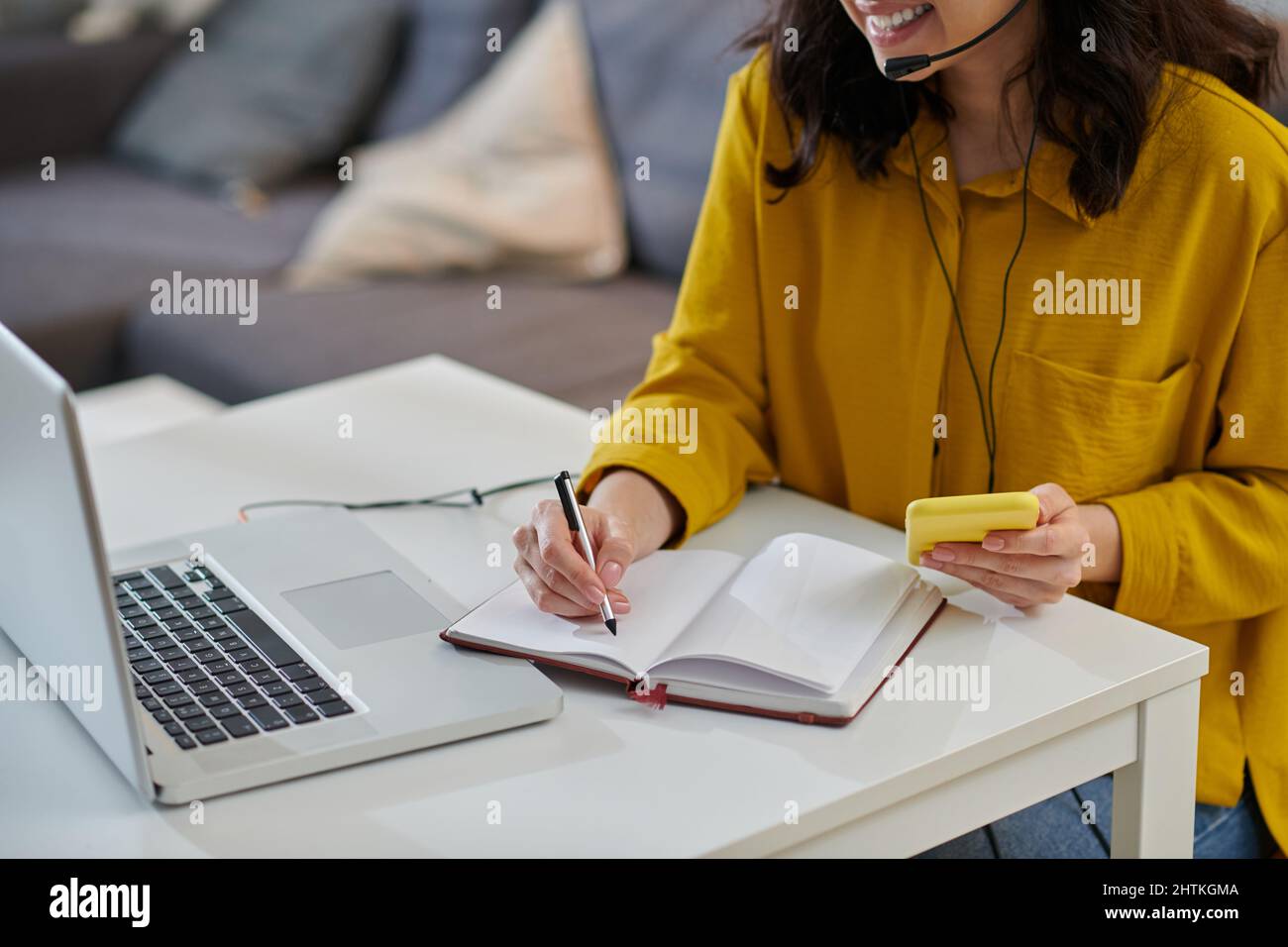 Close up picture of a woman at the laptop making notes Stock Photo - Alamy