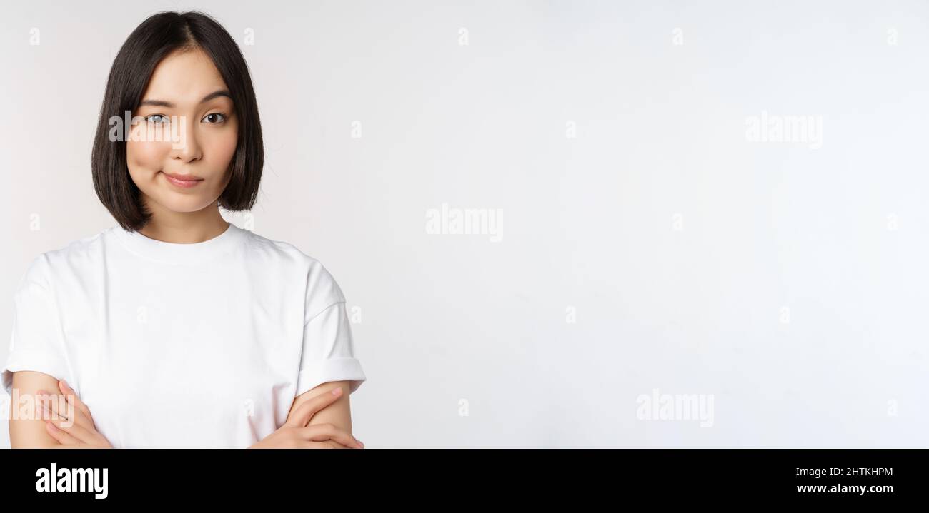Close up of korean girl, looking skeptical, cross arms on chest and ...