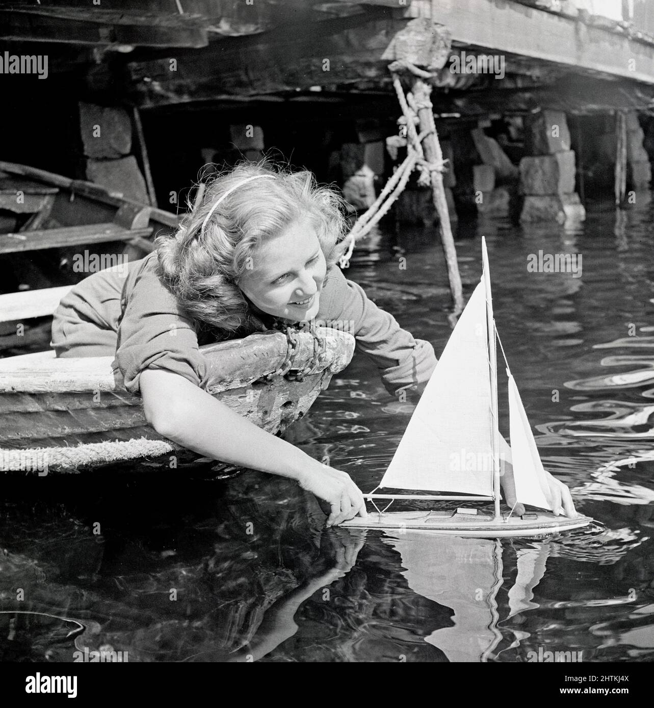 1940s summer. The young actress Inga Landgré plays with a model ...