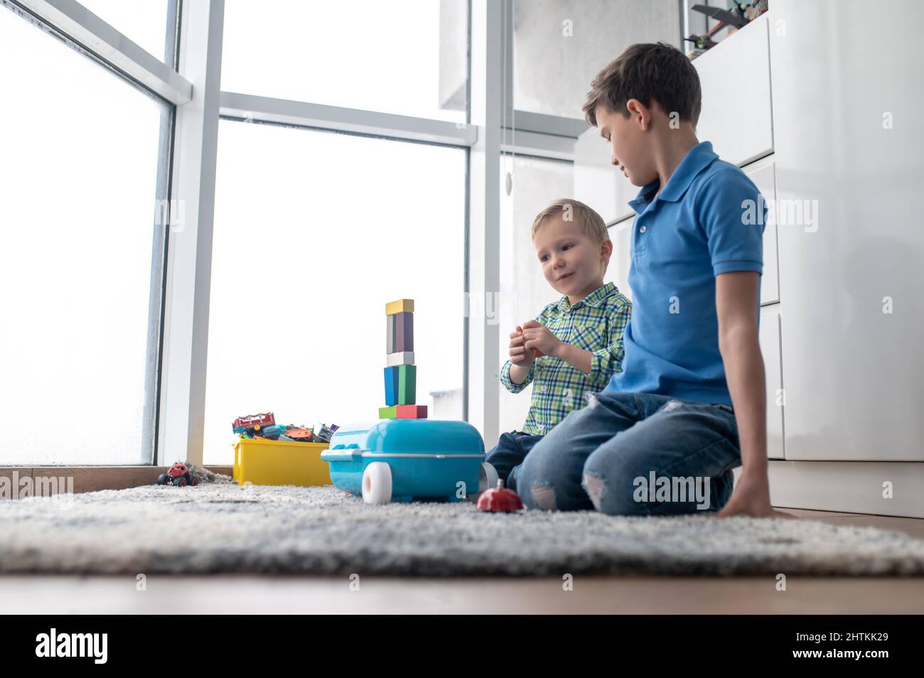 Concentrated little boy building a construction structure Stock Photo ...