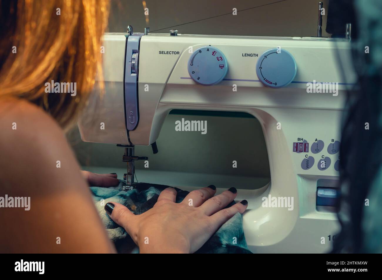 Close up rear view of Argentinian Caucasian woman working in her studio ...