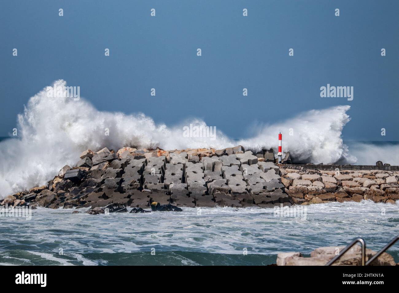 big ocean wave hit in a jetty from a pier in a stormy day Stock Photo ...