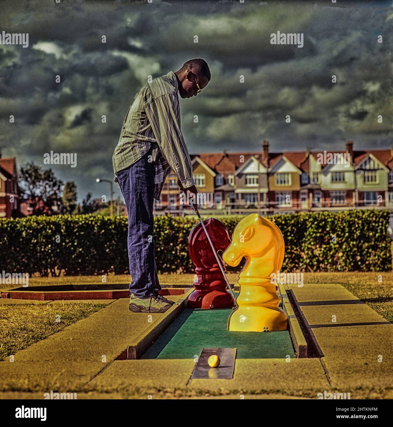 Afro-Caribbean male playing Miniature golf, minigolf, mini-putt, goofy ...