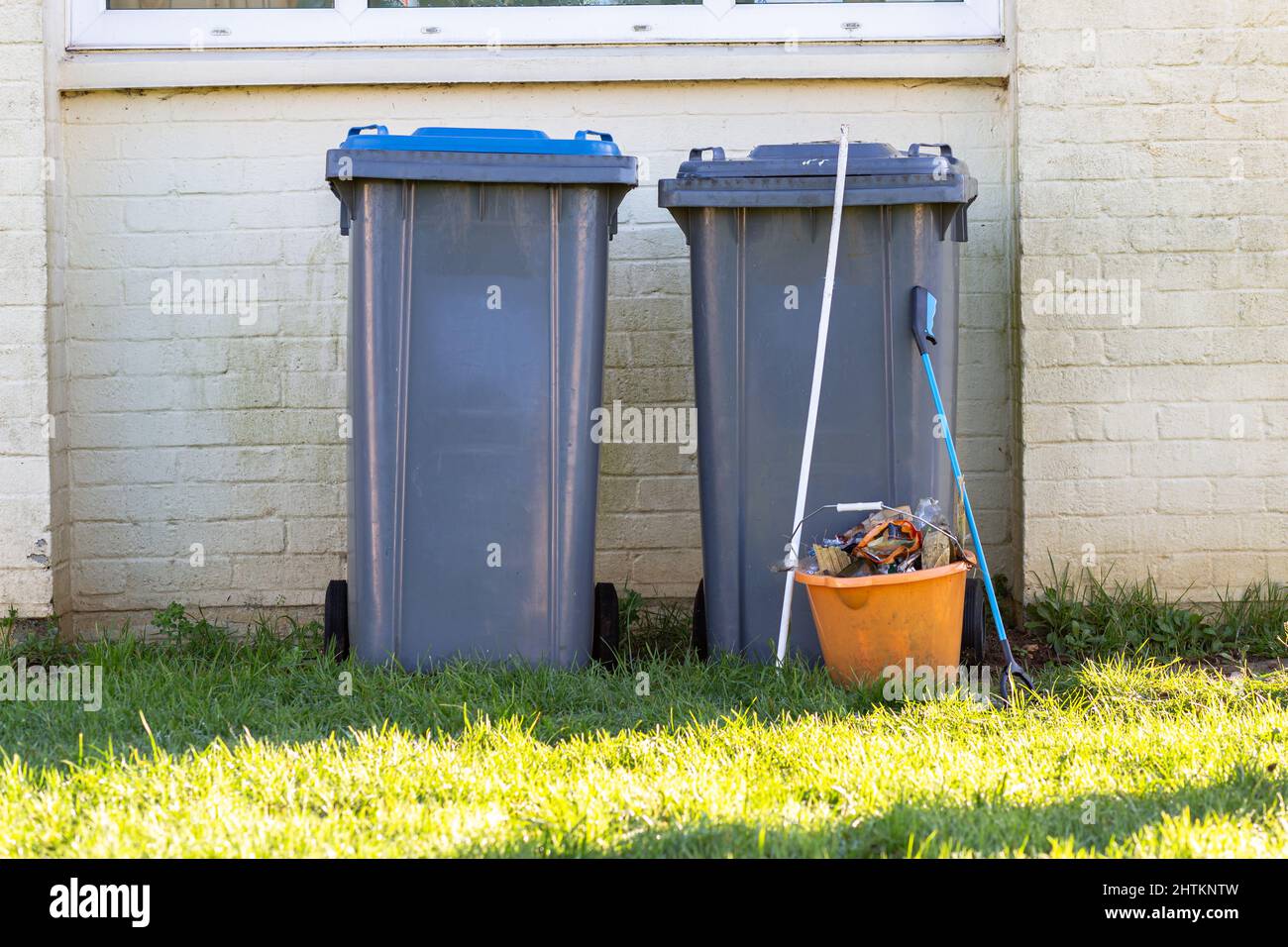 A full bucket of litter that has been collected sitting in front of ...