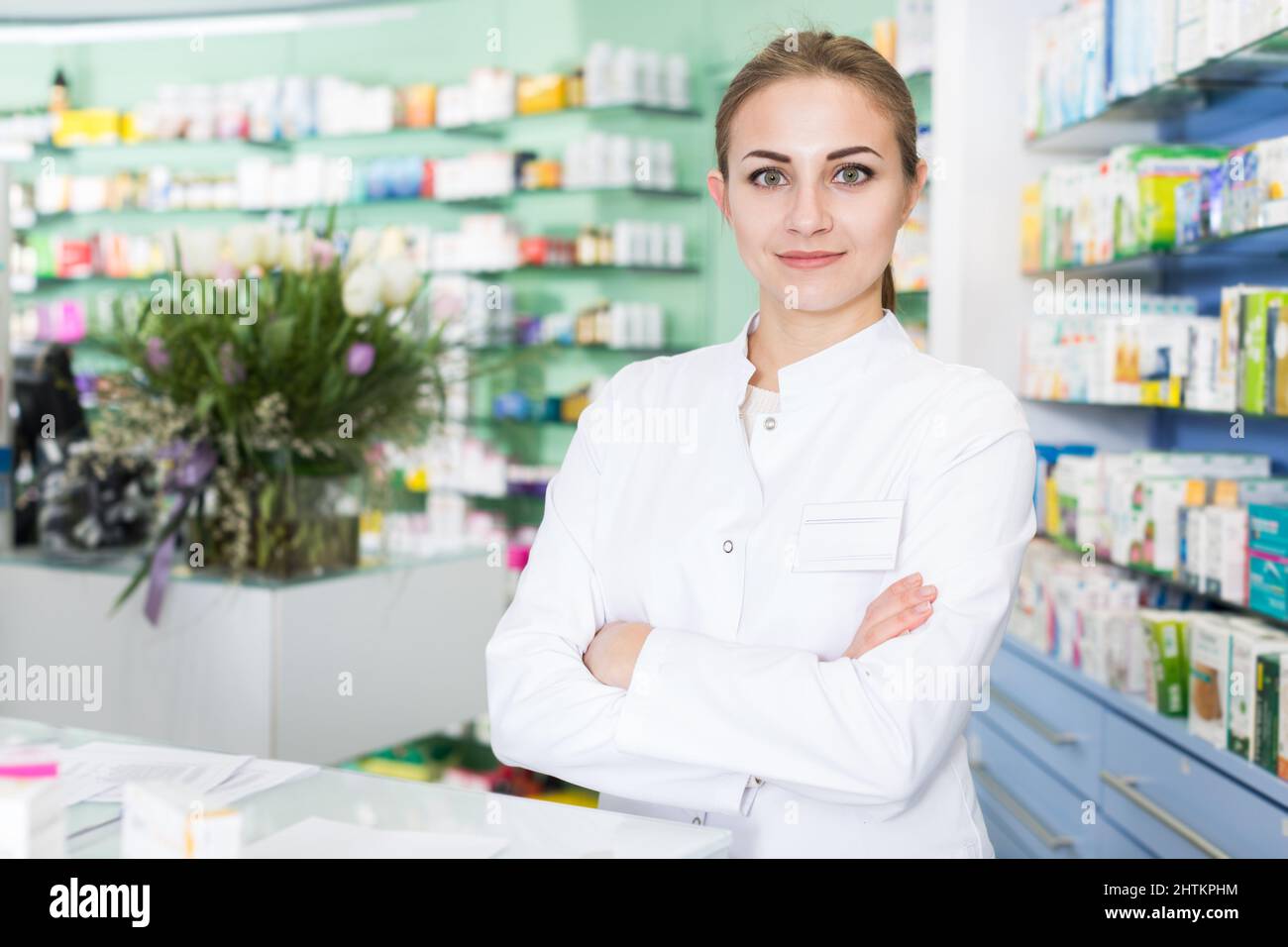 Positive woman pharmacist in uniform is standing in pharmacy Stock ...