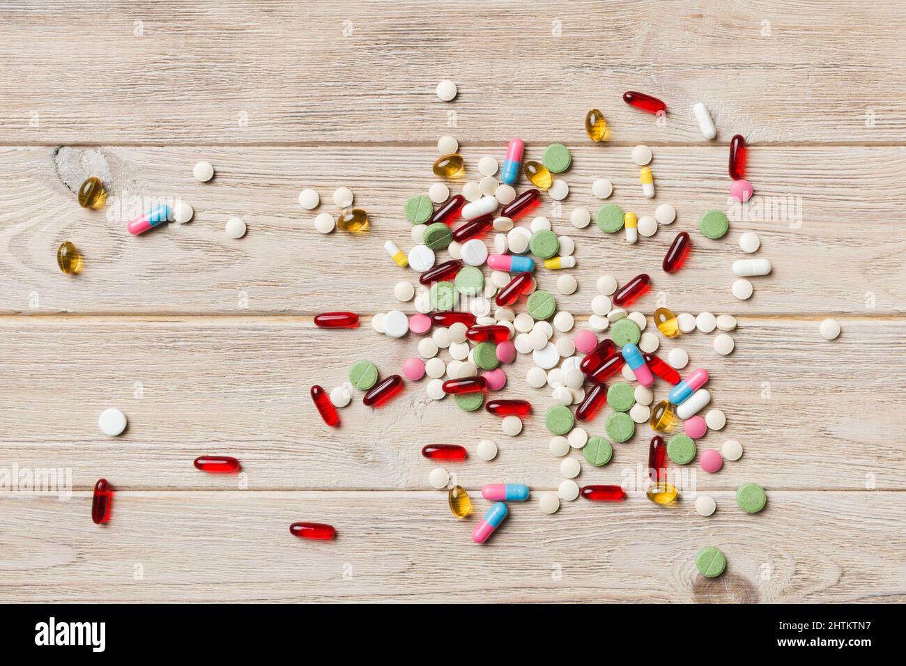 assorted pills and tablets top border over colored background. Many ...