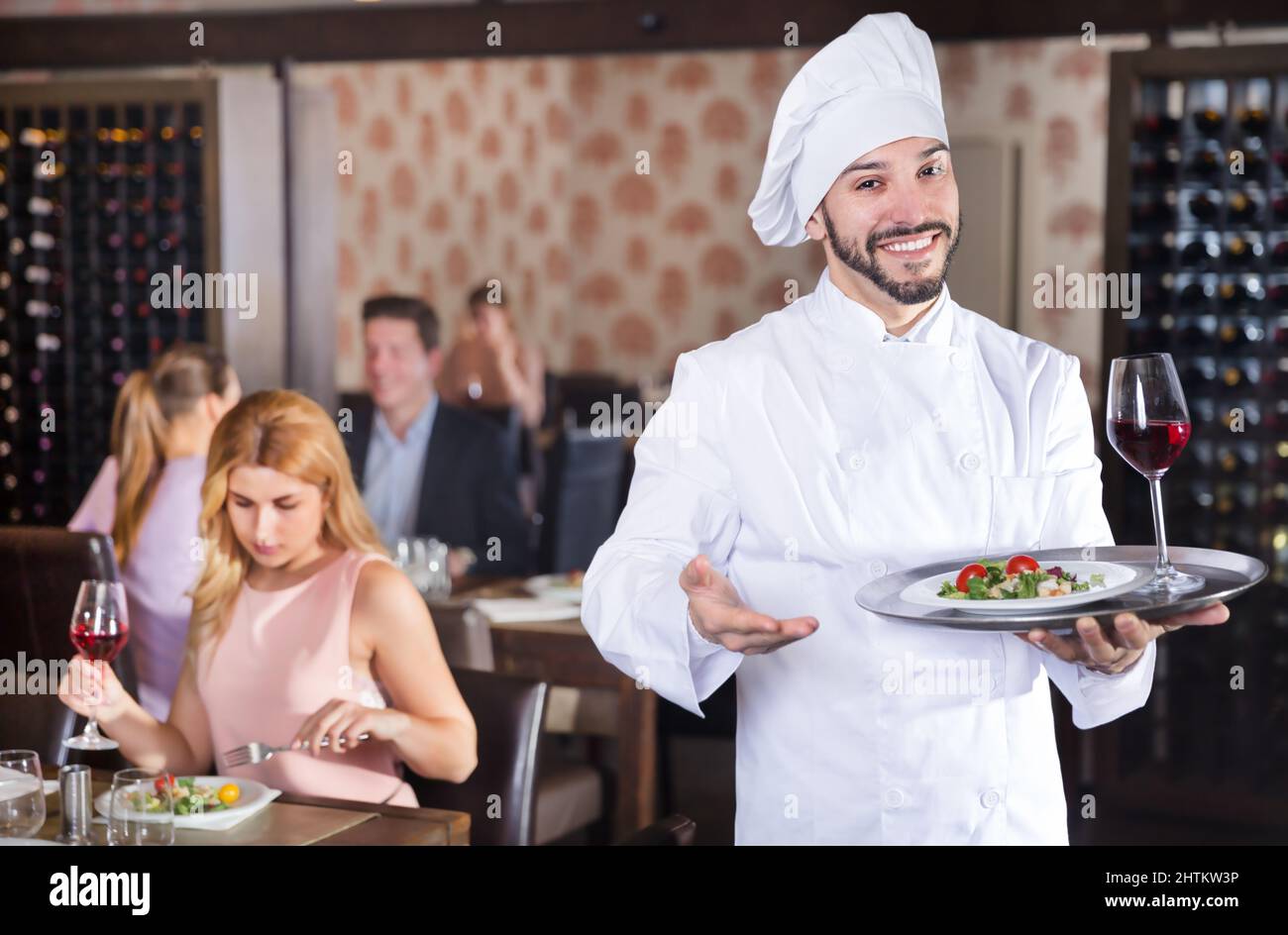 Chef standing with serving tray in restaurant Stock Photo - Alamy