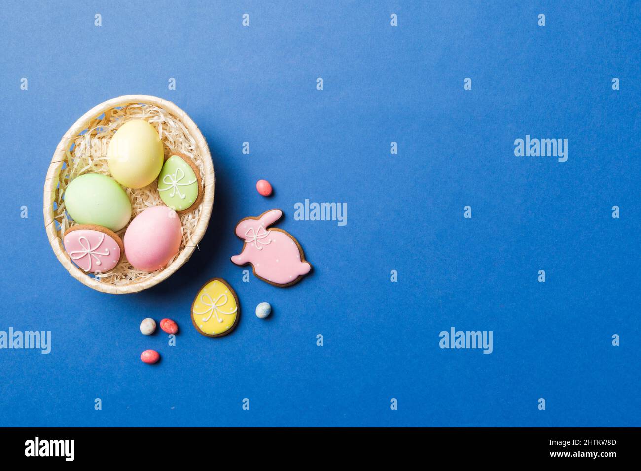 Colorful easter cookies in basket with Multi colors Easter eggs on ...