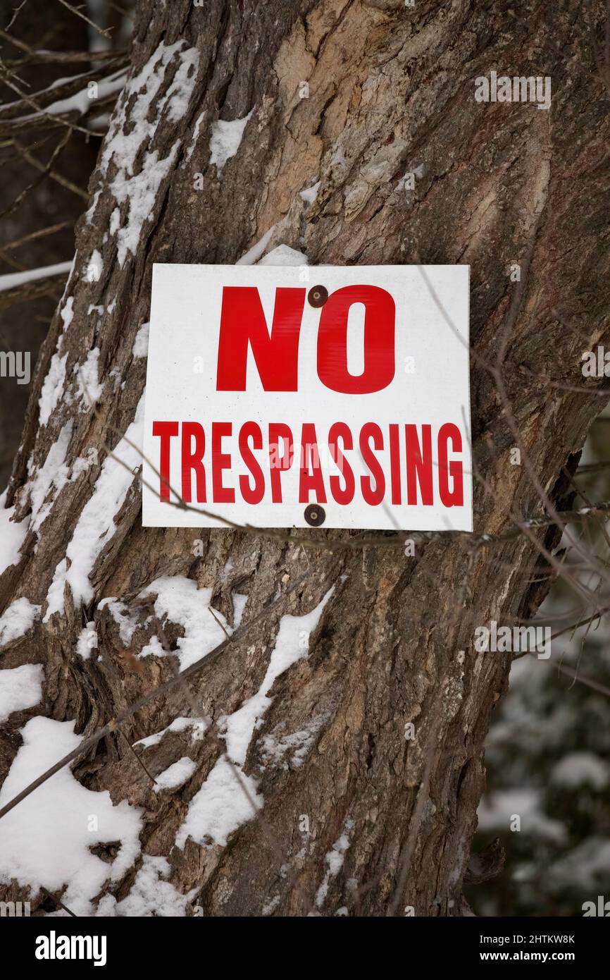 No Trespassing Sign Posted on a Tree Trunk in a Rural Setting Stock ...