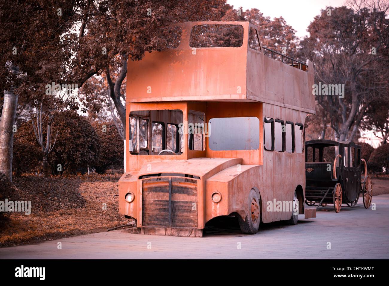 Red old abandoned bus on an empty street in China Stock Photo - Alamy
