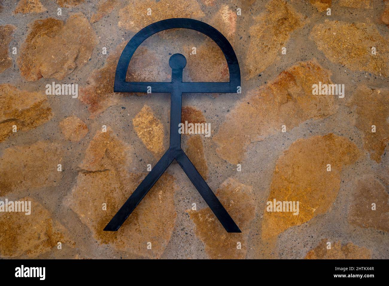 Metal Indalo Man Symbol on a wooden fence. The Indalo is an ancient ...