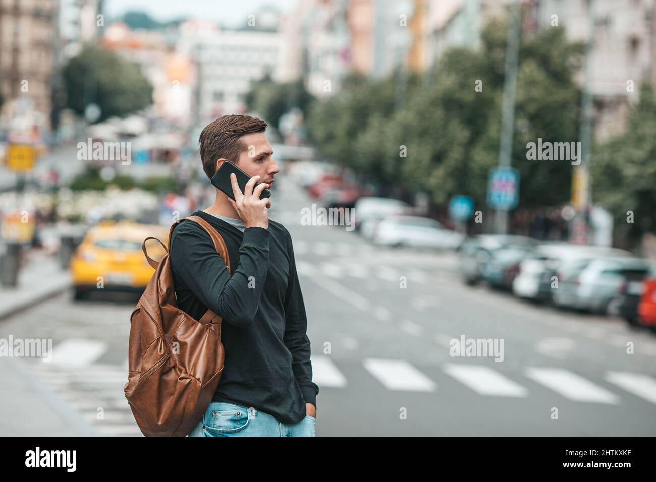Young man holding mobile phone, using smartphone, making a call and ...