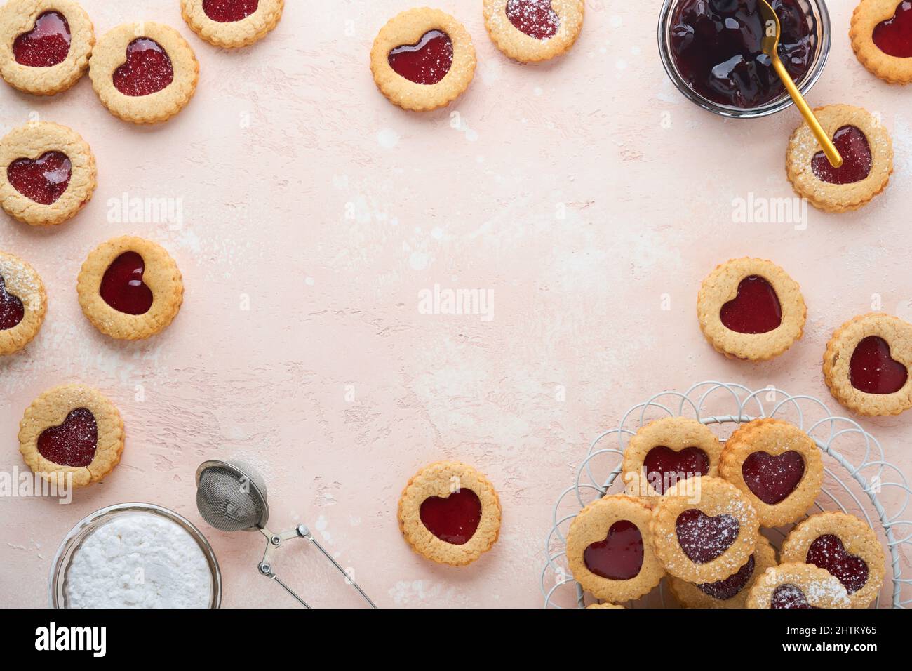 Traditional Linzer cookie with strawberry jam and powder sugar on pink ...