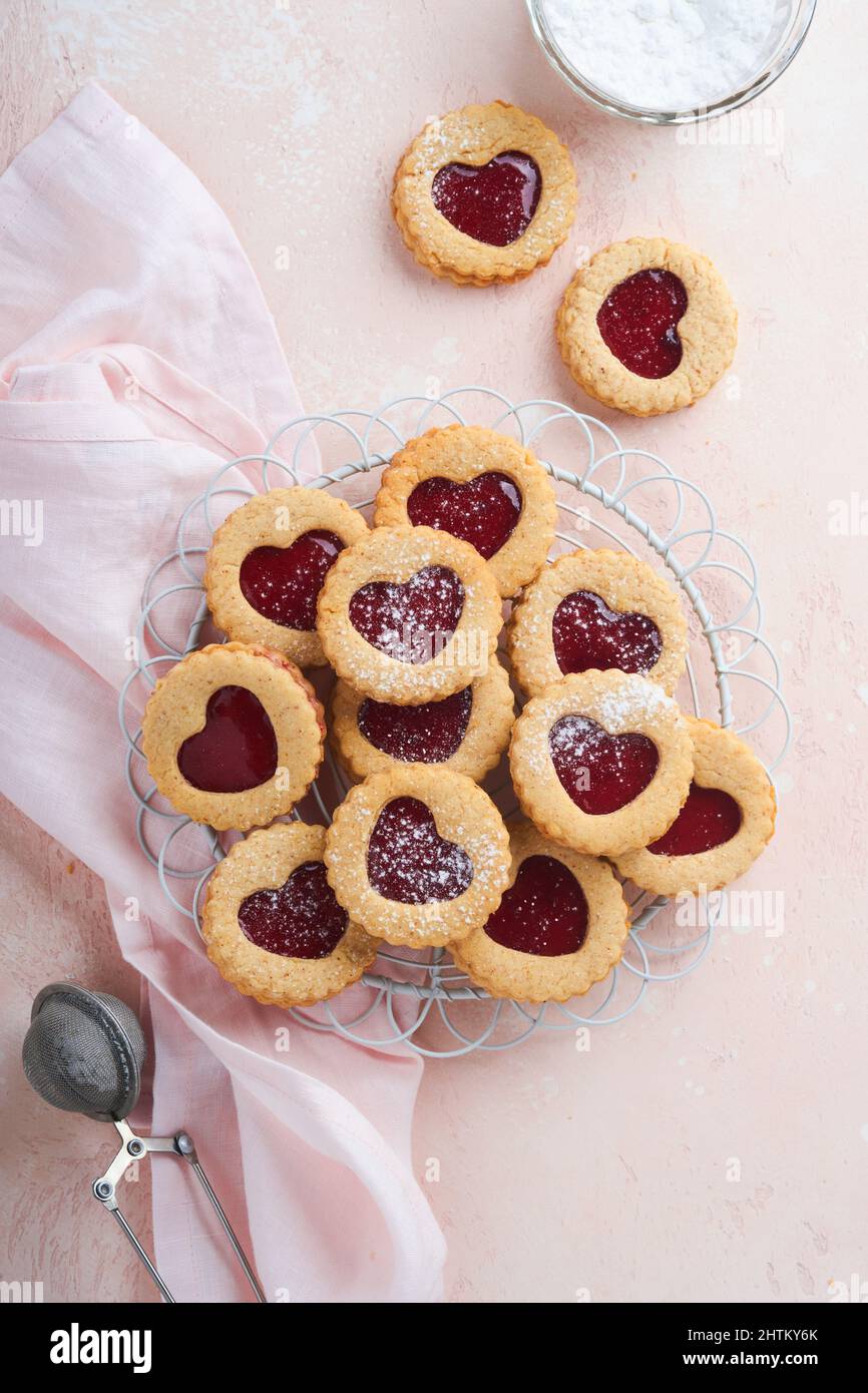 Traditional Linzer cookie with strawberry jam and powder sugar on pink ...