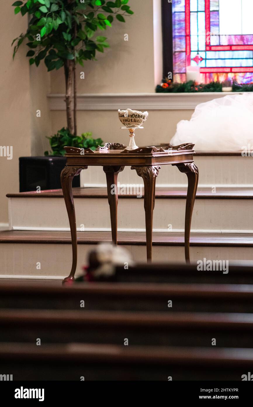 Vertical shot of a handmade clay prayer lamp on a wooden table in the ...