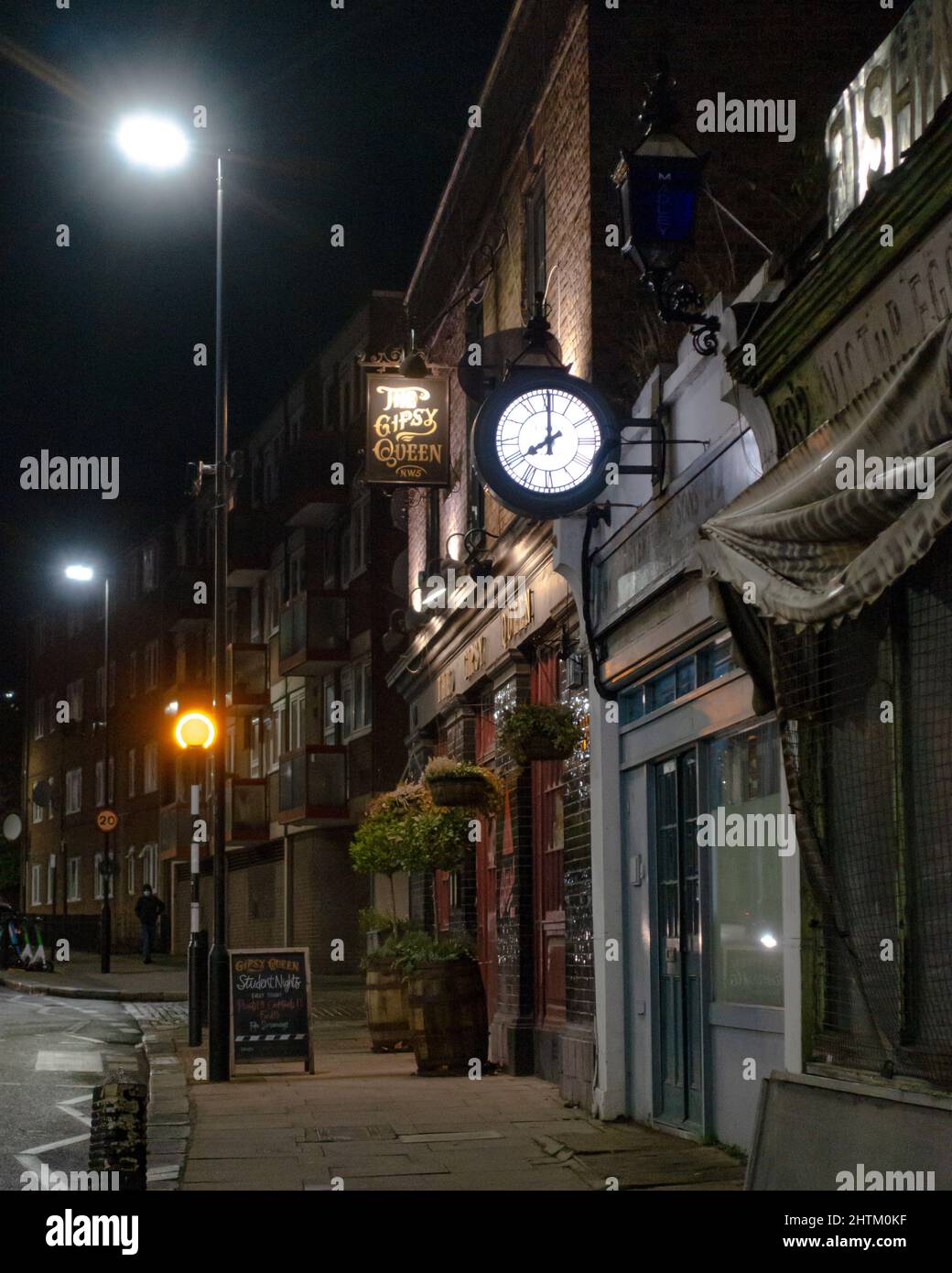 Closeup of the Gypsy Queen Pub and a Clock at night Stock Photo - Alamy