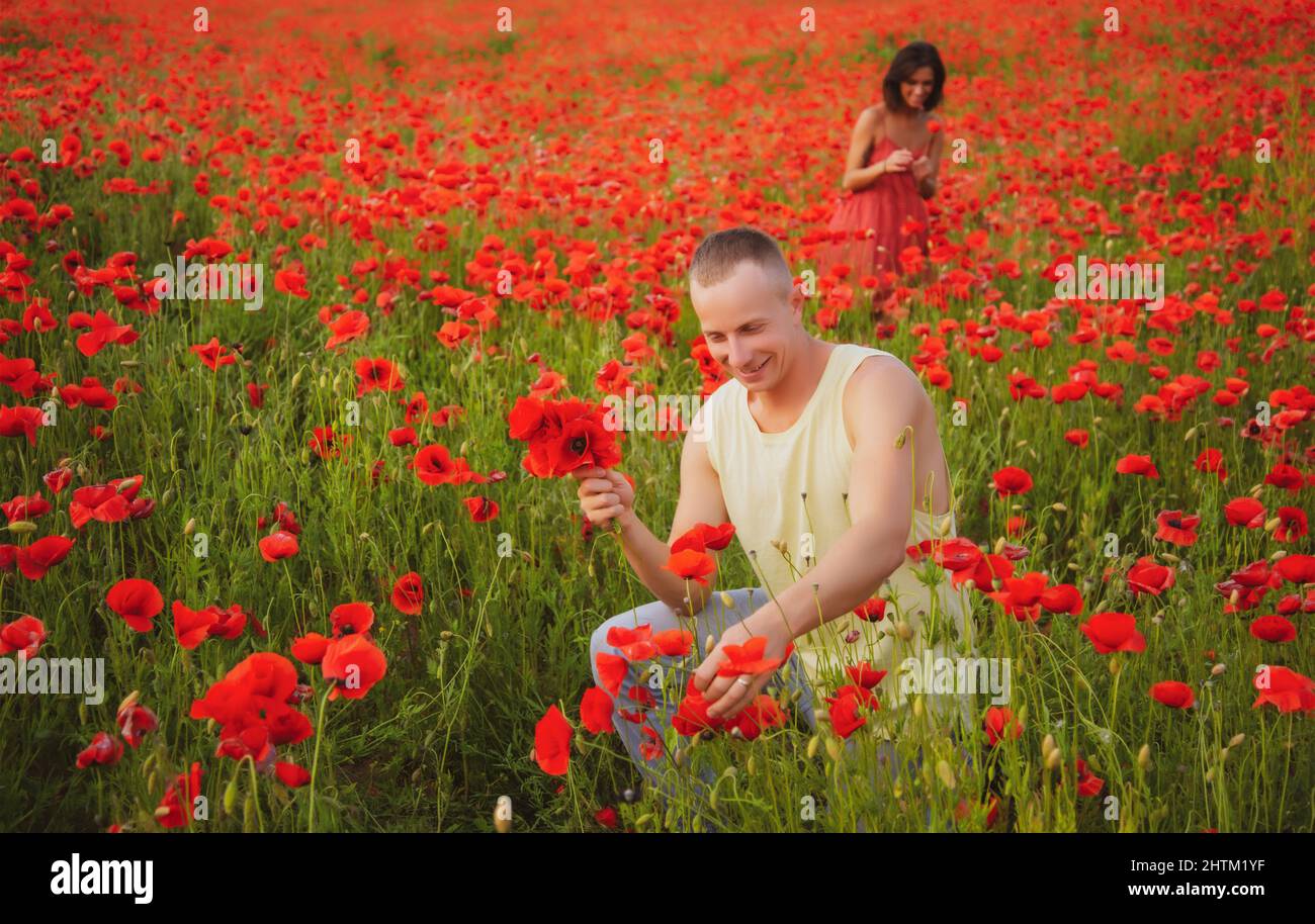 Happy couple in love tenderness on poppy spring field. Well being ...