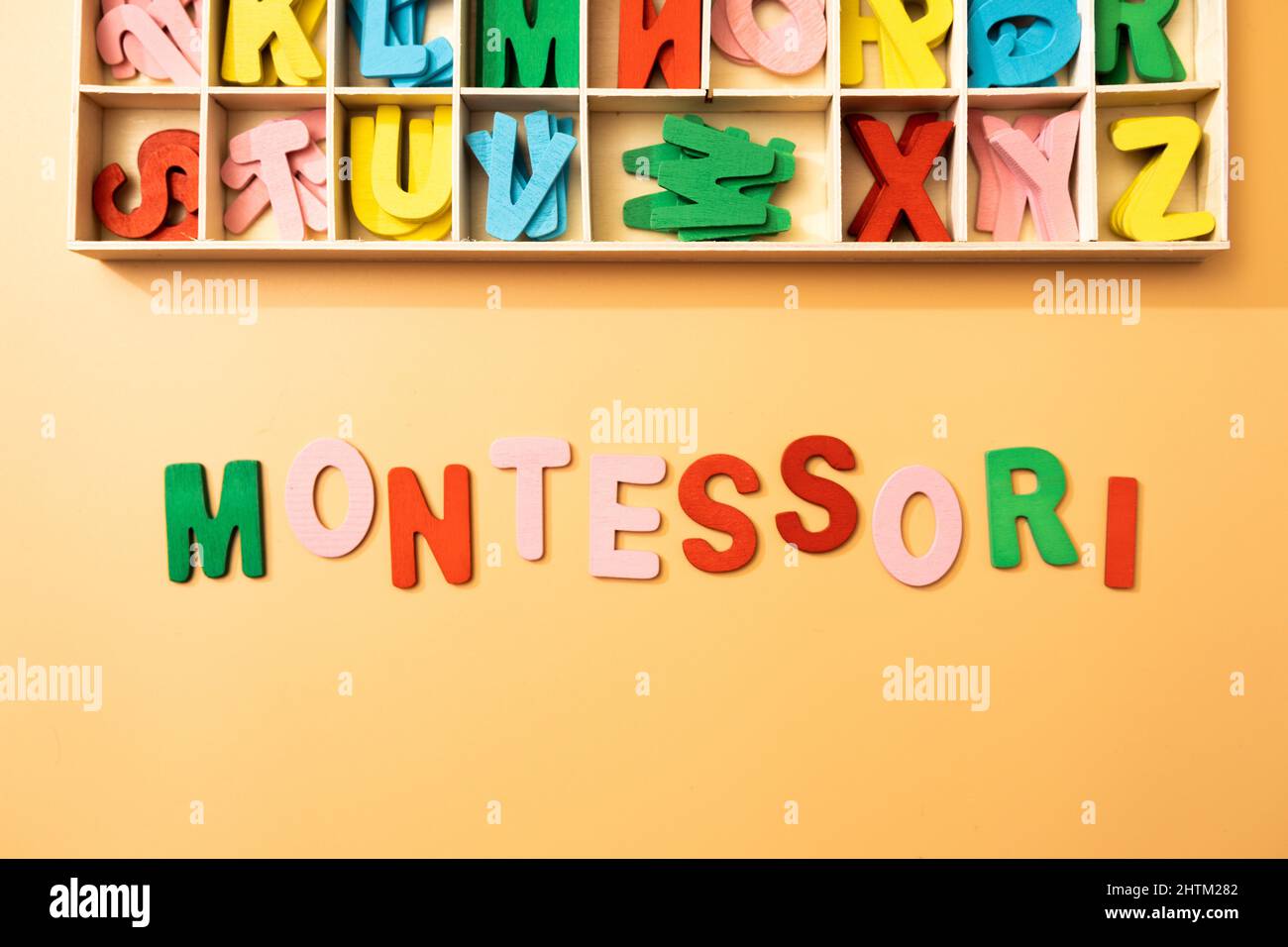 the word montessori represented as a concept by wooden color letters ...