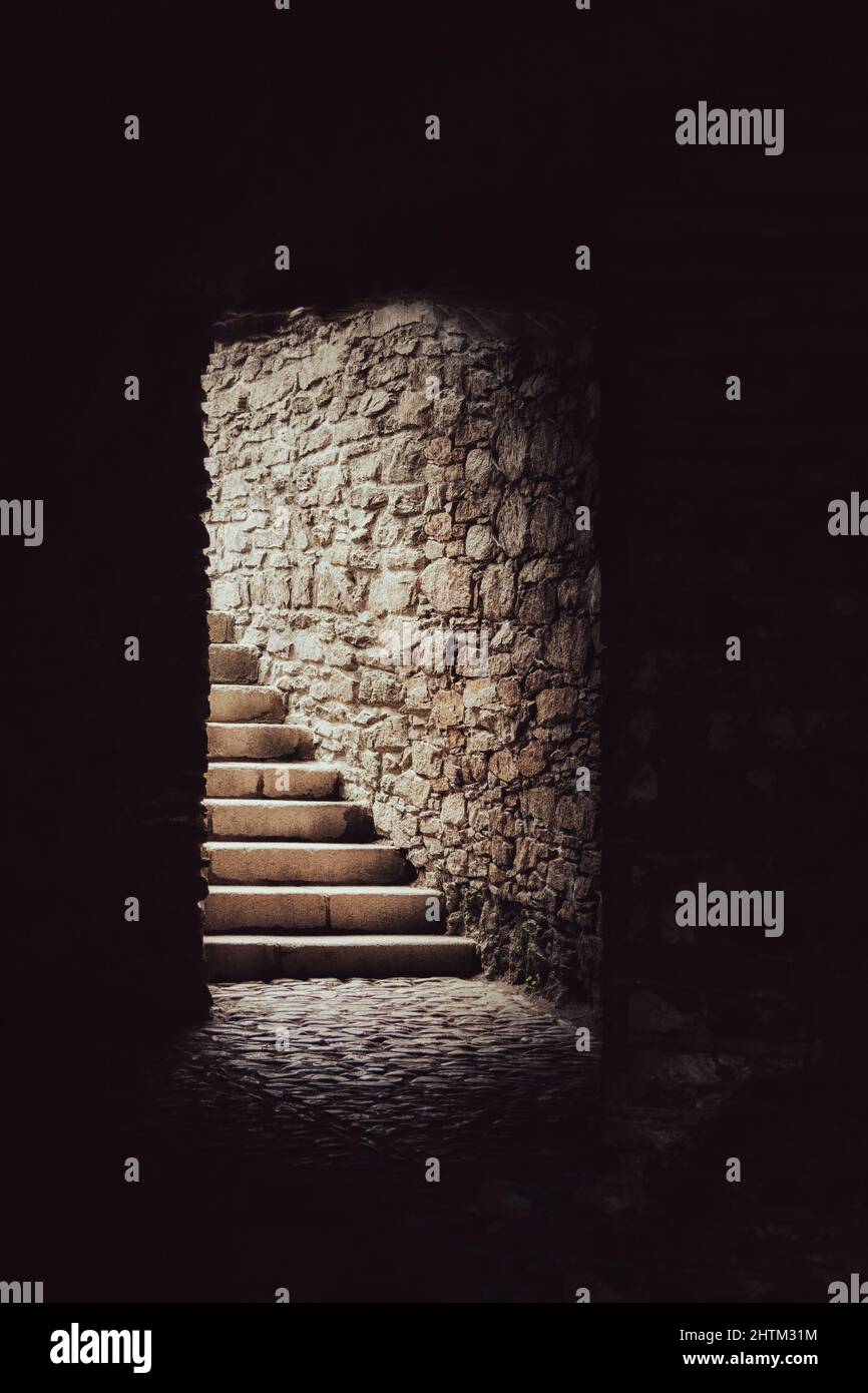 Light on stone stairs in a dark basement Stock Photo - Alamy