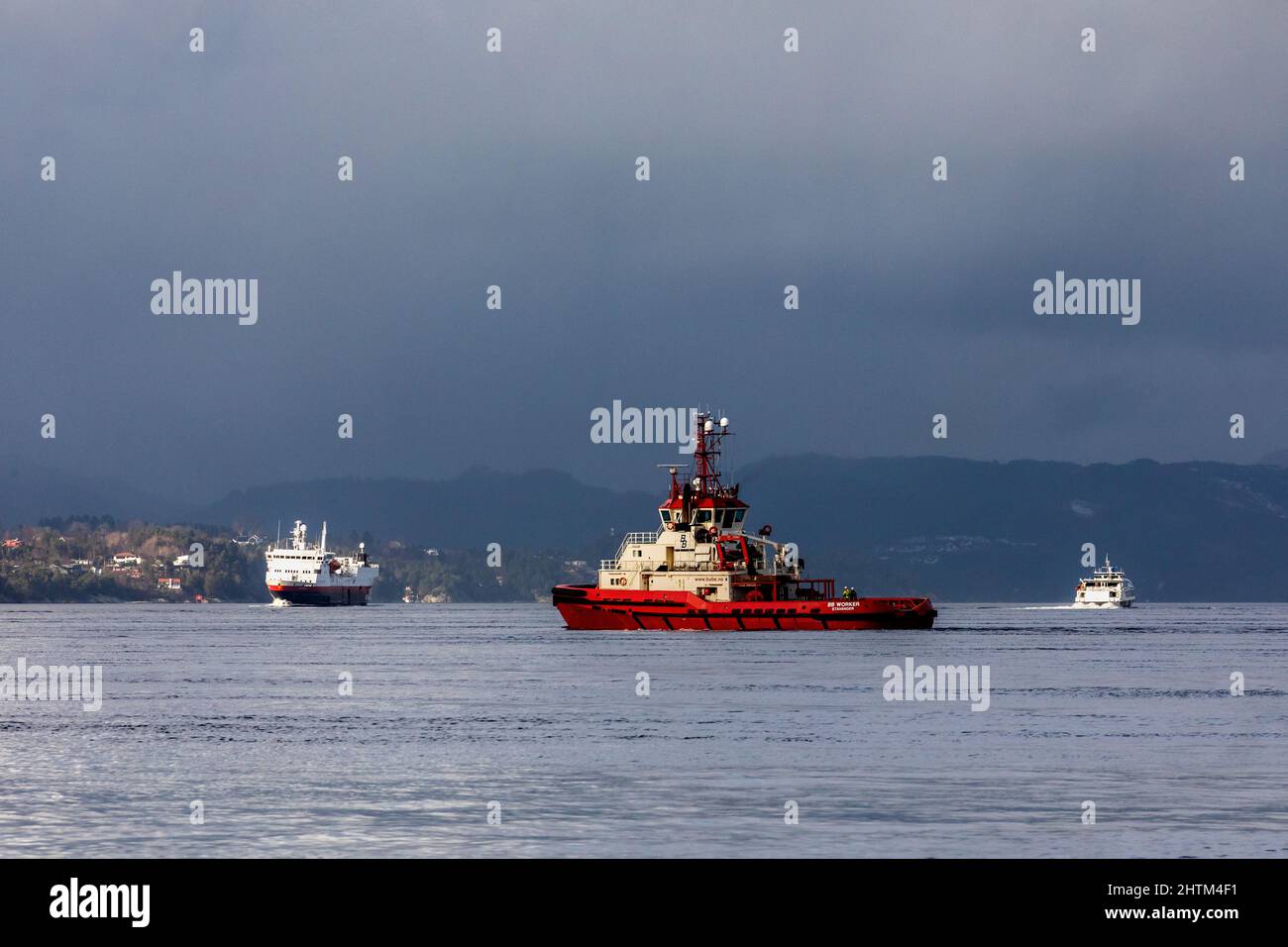 Tug boat BB Worker at Byfjorden, outside the port of Bergen, Norway Hurtigrute skipet Vesterålen ...