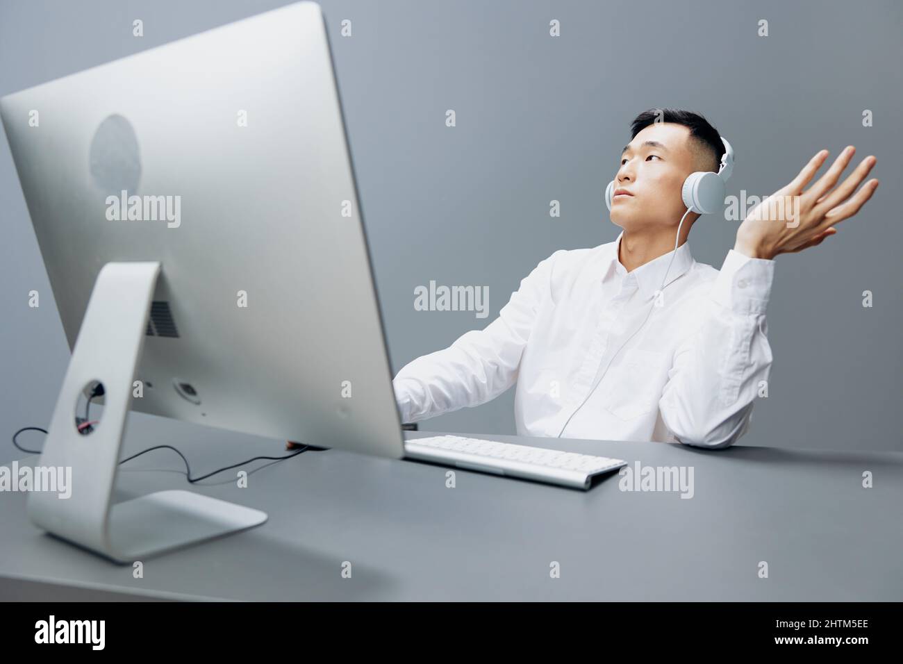 businessmen in front of the computer with headphones emotions isolated ...