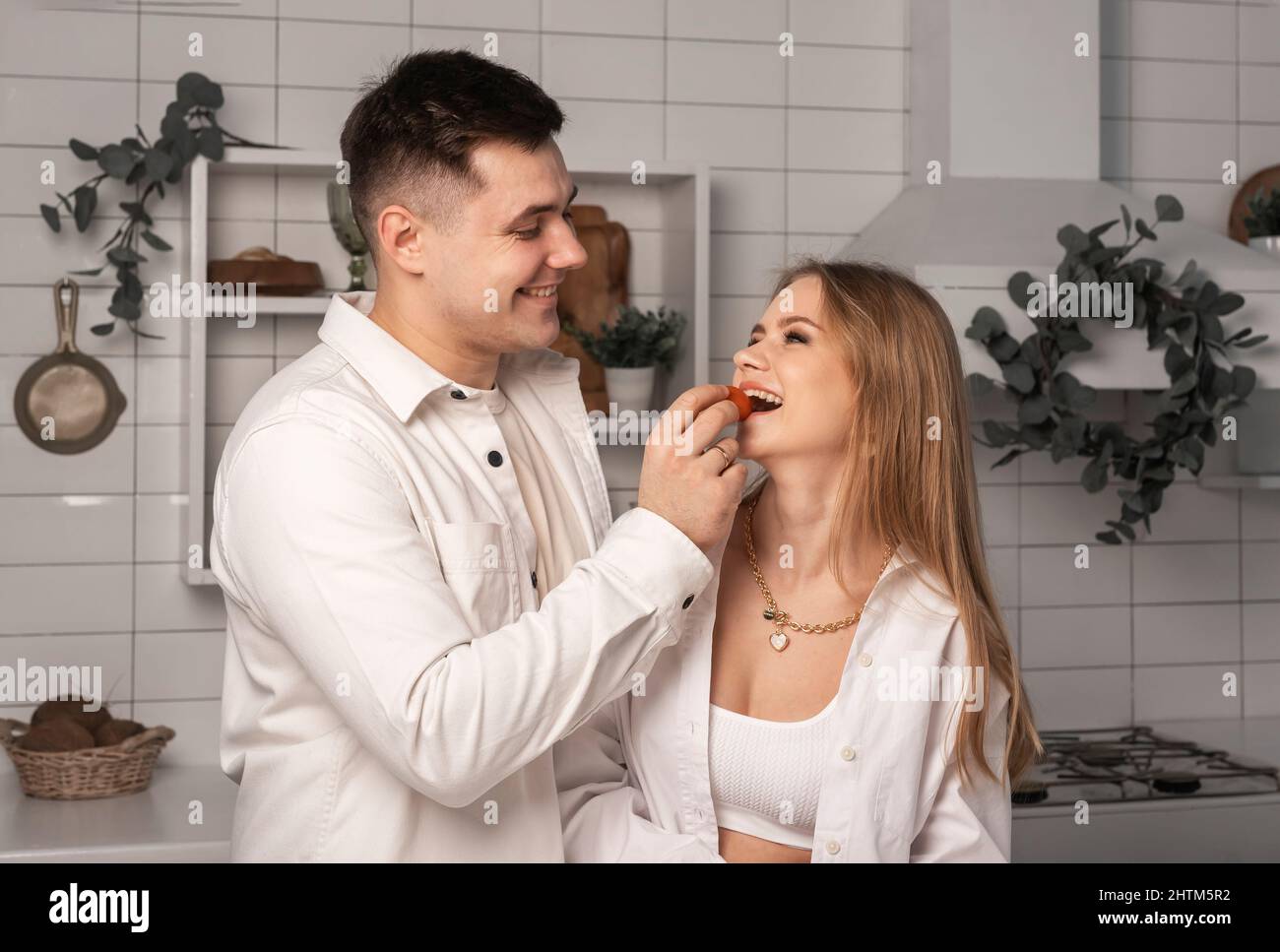 Romantic young woman feeding boyfriend hi-res stock photography and ...