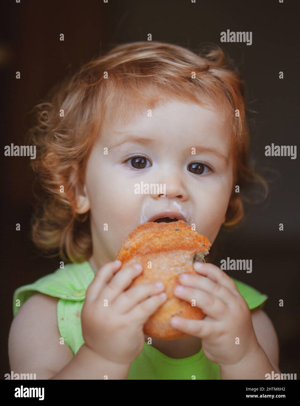 Baby with bread. Cute toddler child eating sandwich, self feeding ...