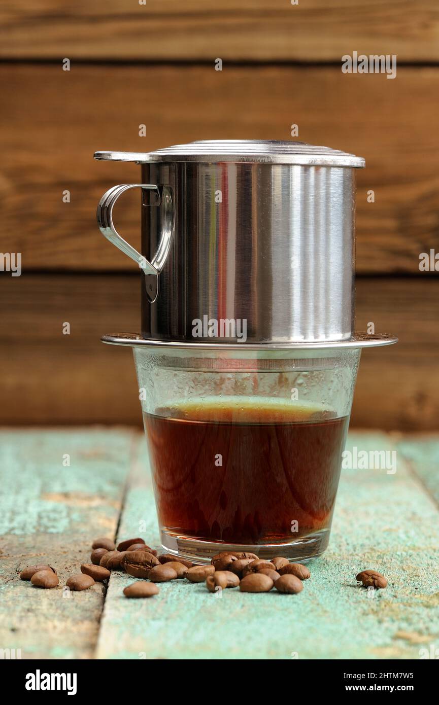 Coffee brewed in small metal French drip filter vertical Stock Photo ...