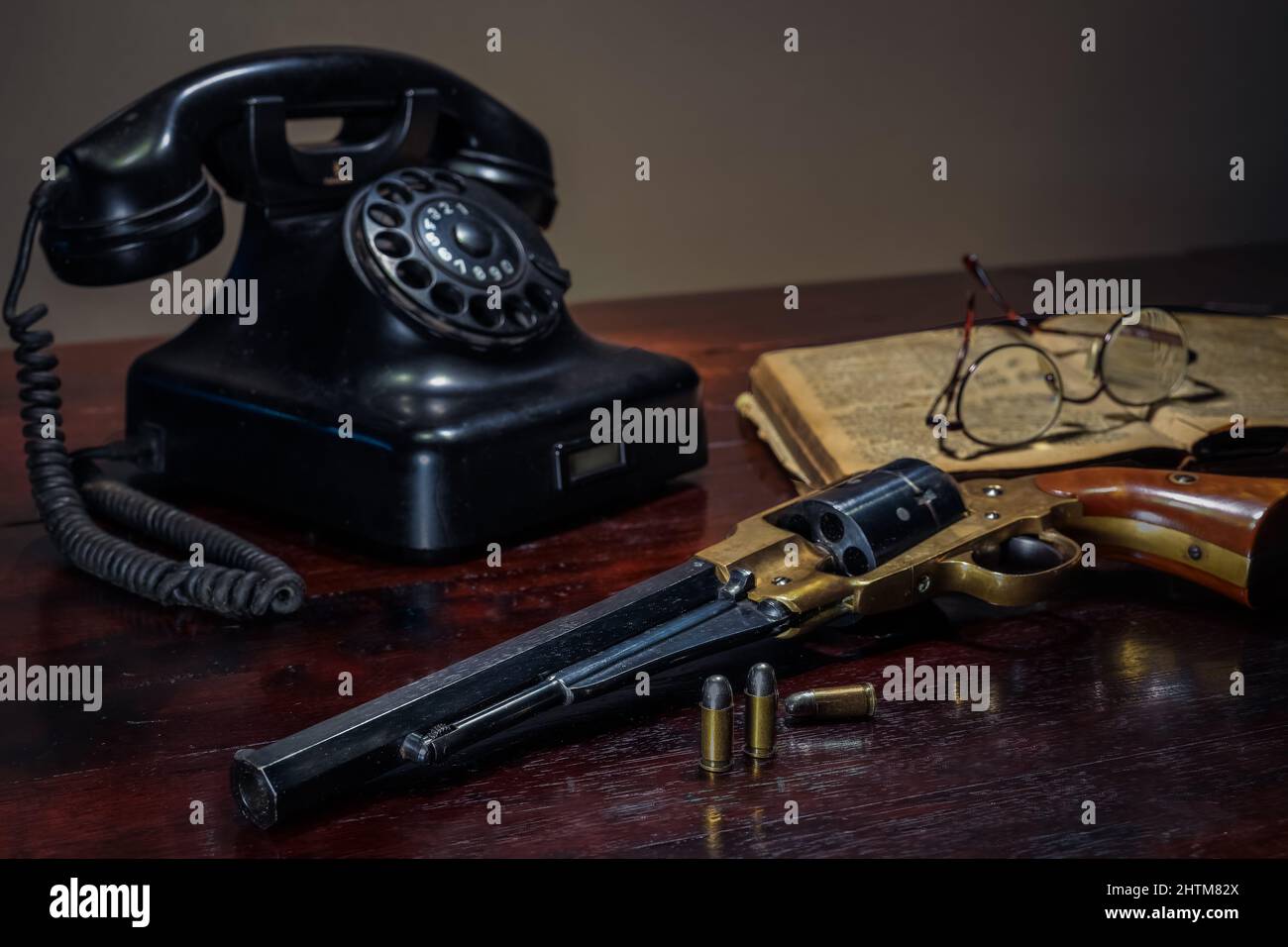 Vintage telephone, gun, glasses and book Stock Photo - Alamy