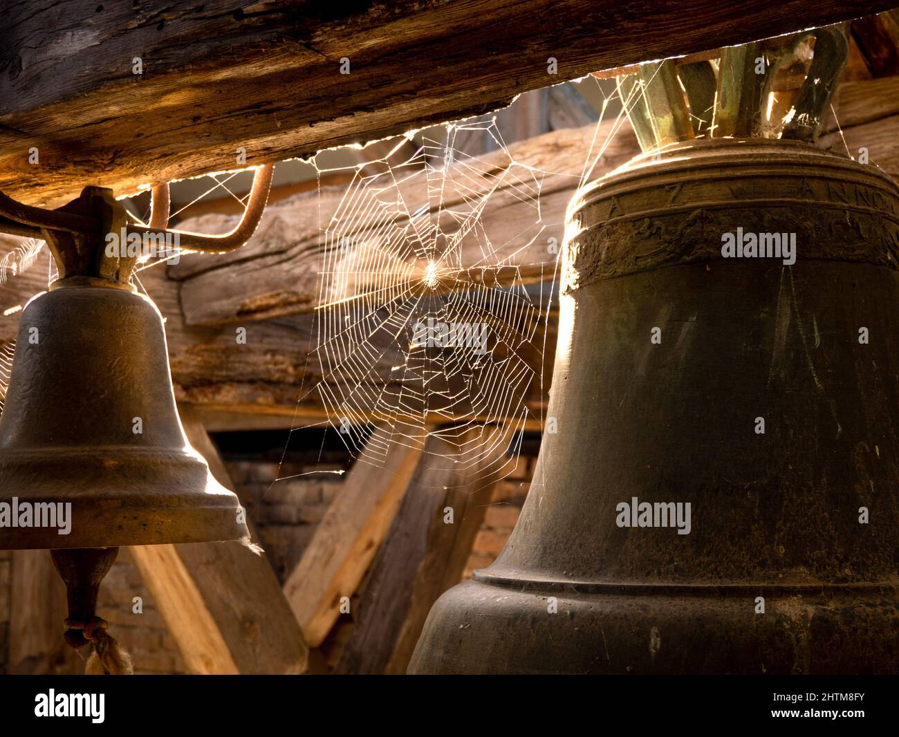 Closeup of bells inside a church with spider webs Stock Photo - Alamy