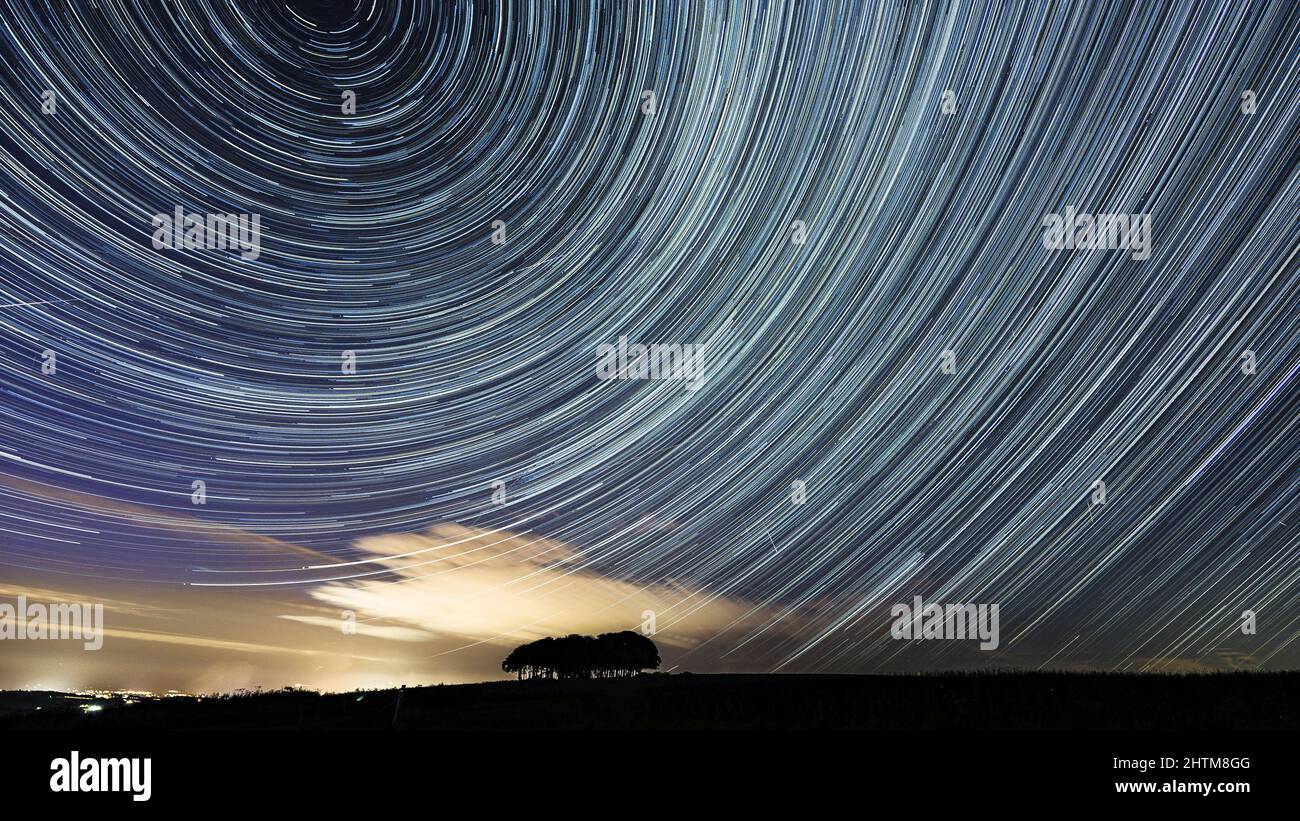 Landscape of a field under a starry sky with long exposure in the ...